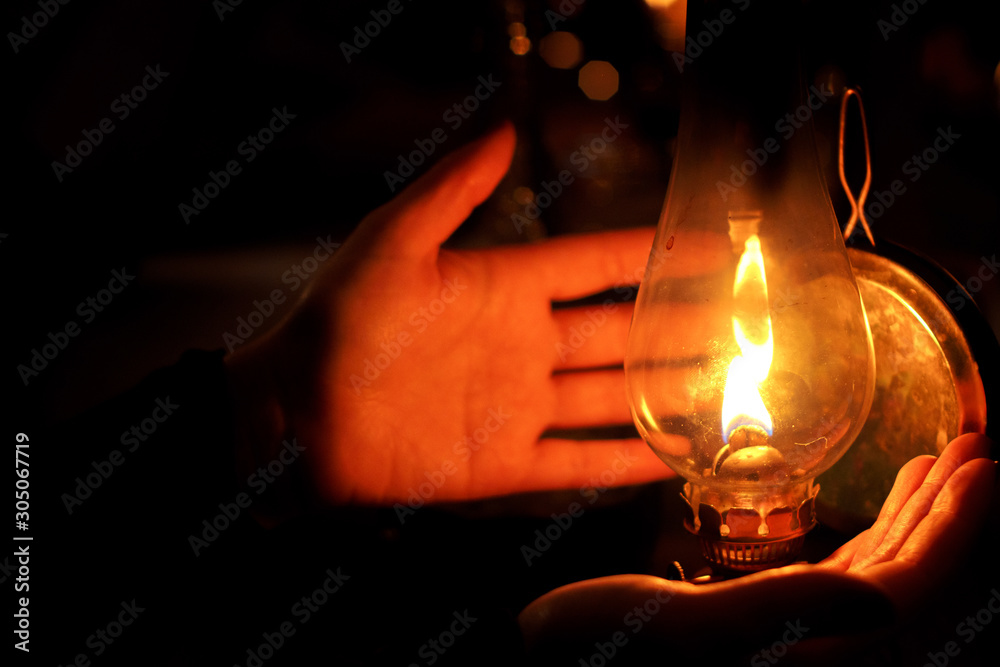 Hands next to oil lamp Stock Photo | Adobe Stock