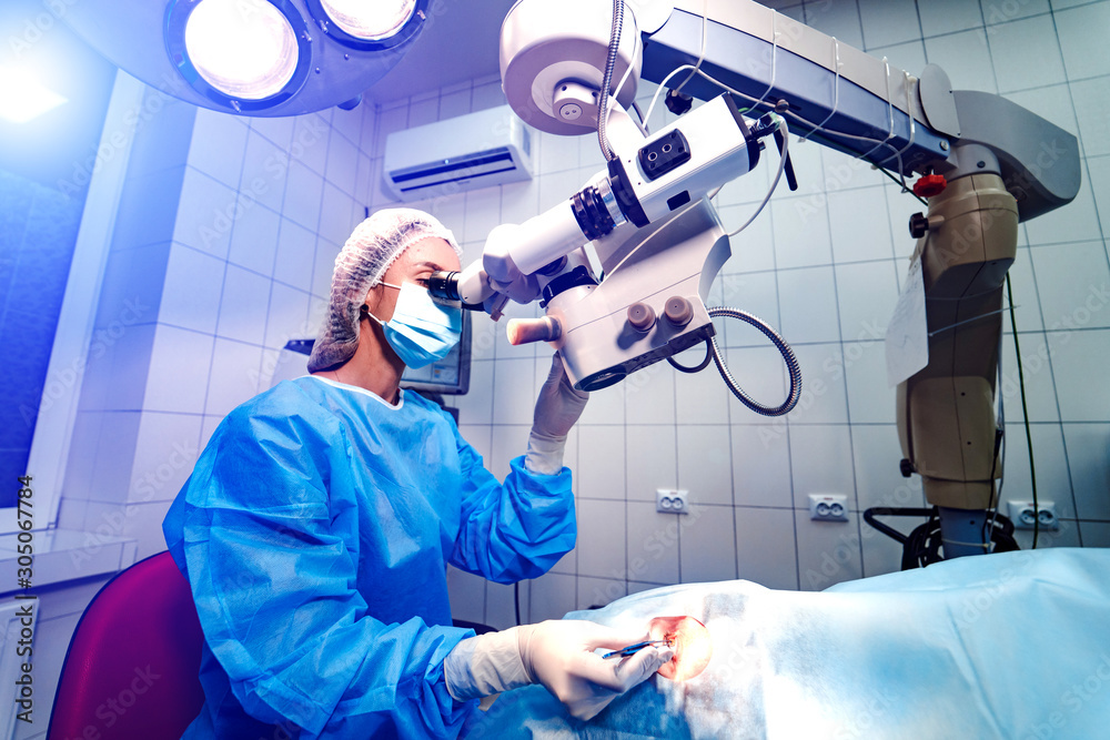Eye surgery. A patient and surgeon in the operating room during ...