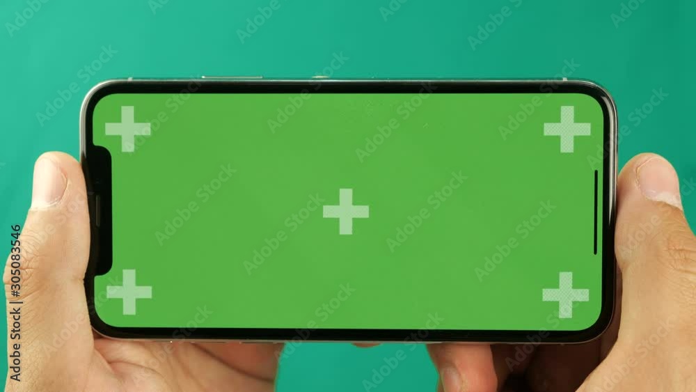 Video Stock Horizontal smartphone in the hand closeup isolated at green ...