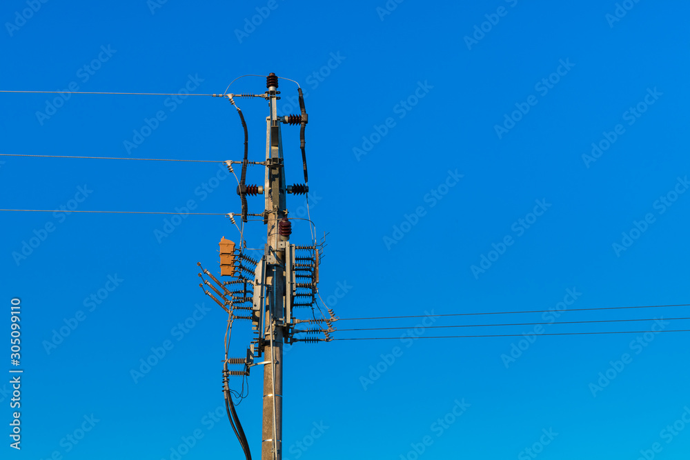 Medium voltage disconnectors on electricity pylon on blue sky ...