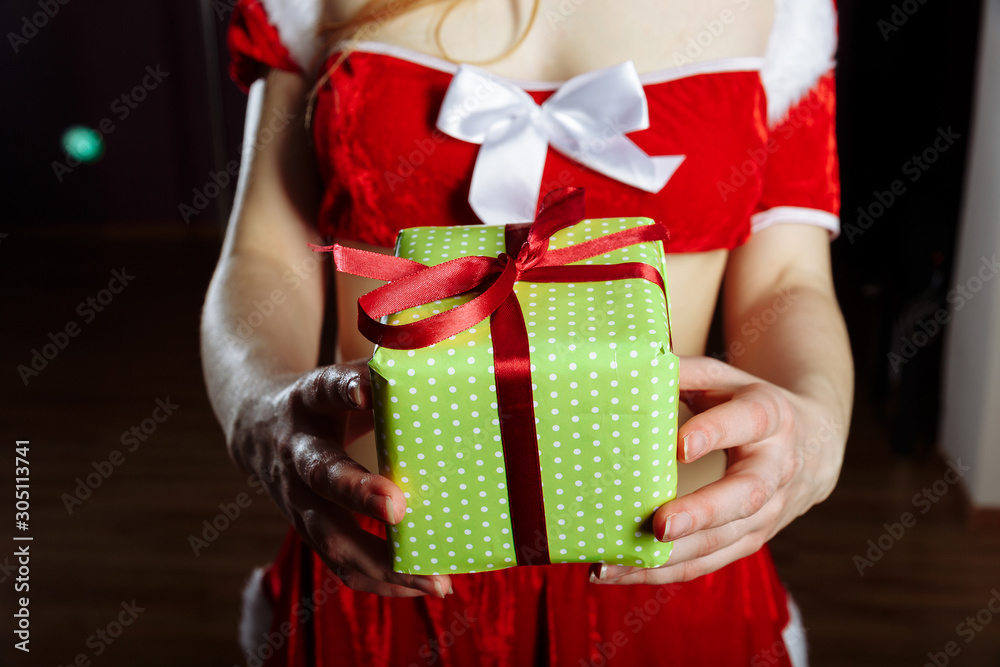 Beautiful Redhead Strip Tease Girl In A Dress And Santa Hat Is Standing