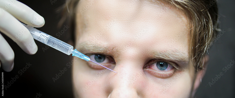 man is undergoing Botox treatment in a beauty clinic. Nasal bridge ...
