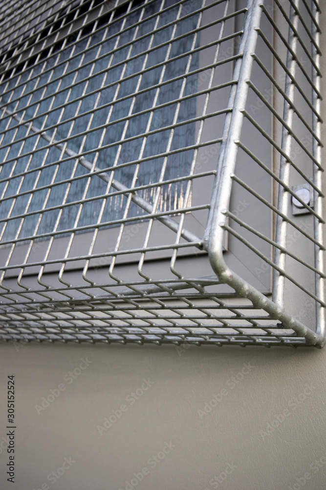 Window security wire mesh frame fixed externally to building wall to ...