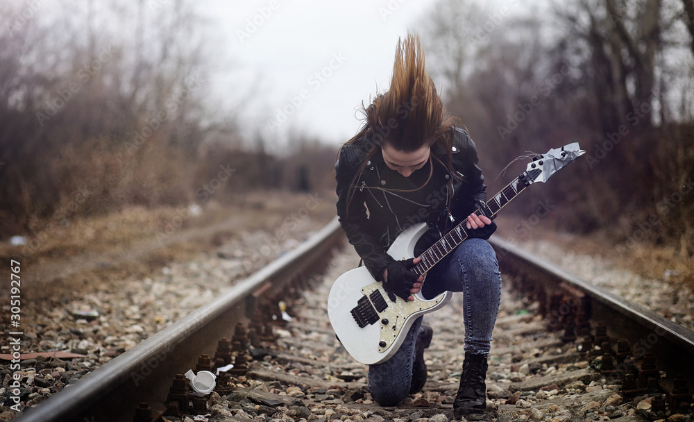 Beautiful young girl rocker with electric guitar. A rock musician girl ...