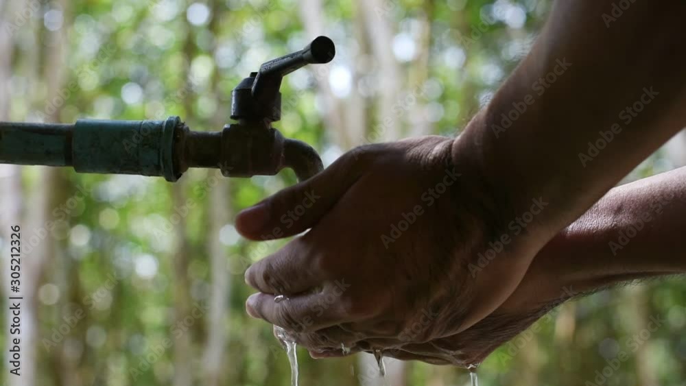Hand washing on blur green nature background, Water energy conservative ...