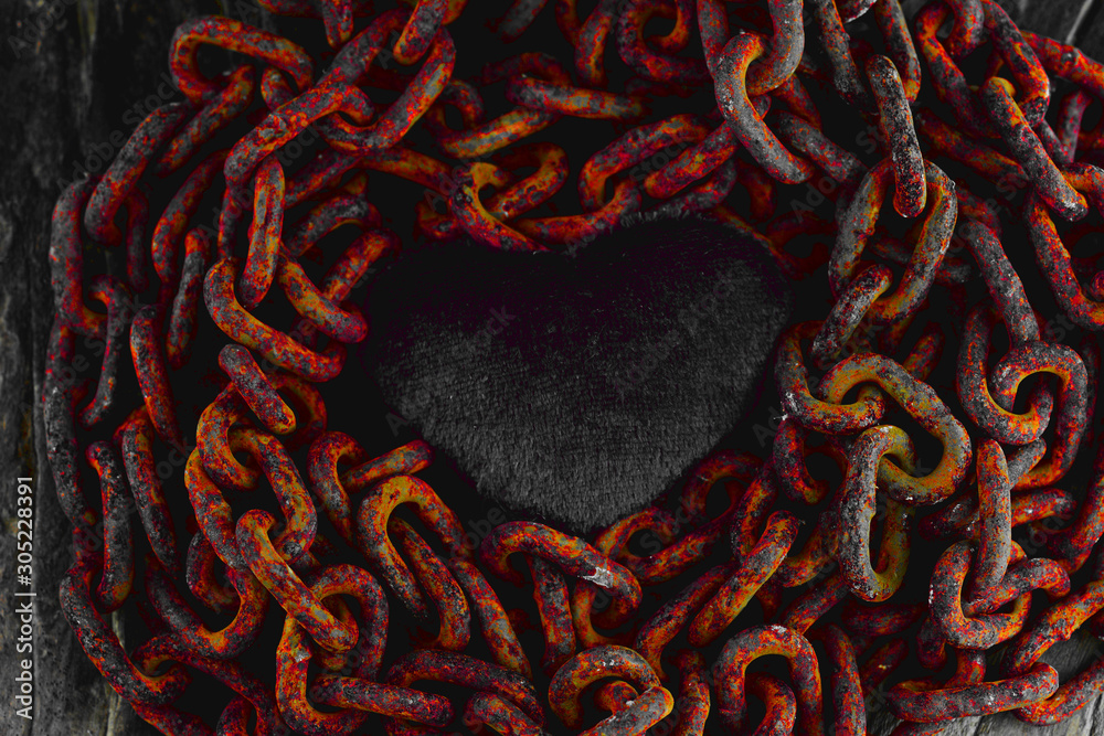Rusty chains around the black heart, the background for the love ...