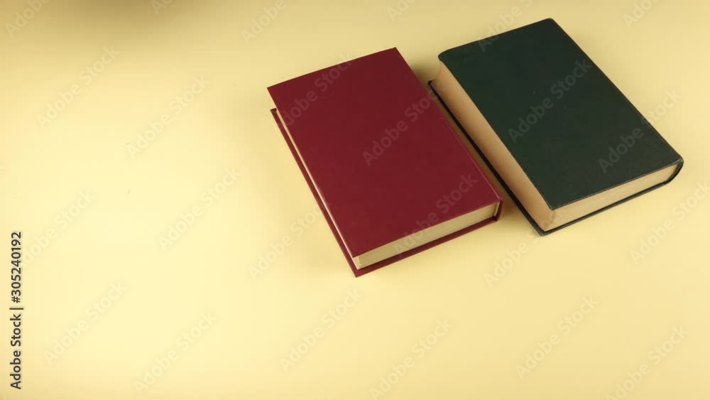 three books of red blue and green are placed side by side on a light ...