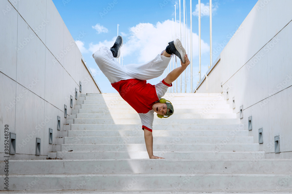 Dancer doing handstand on stairs Stock Photo | Adobe Stock