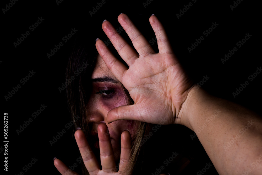 Stopping violence against women, Woman covering her face in fear of ...