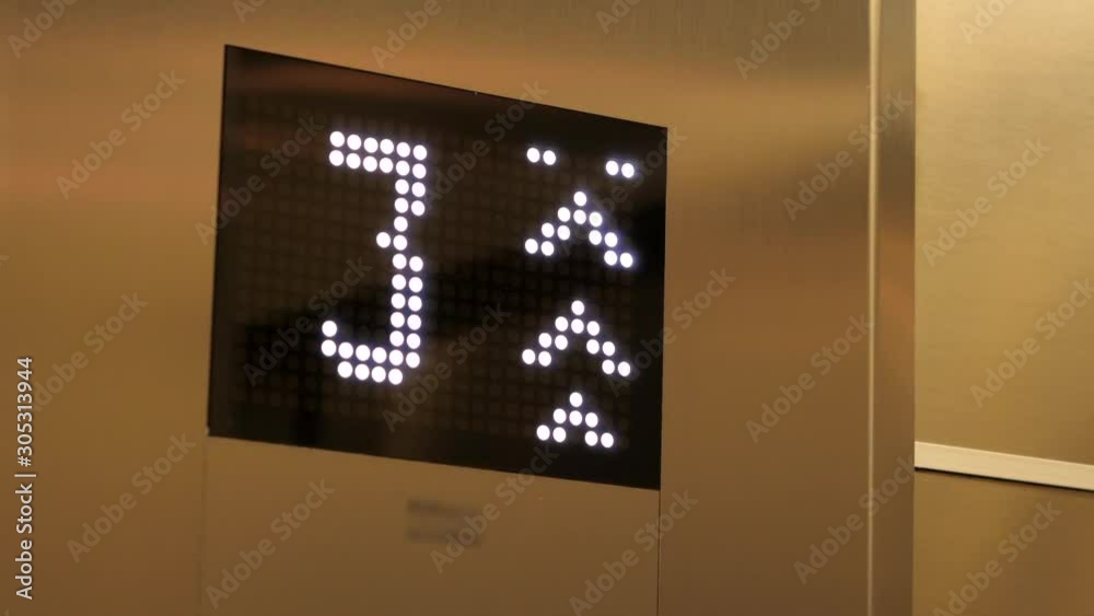 Display of an elevator going up indicating the floor number passing ...