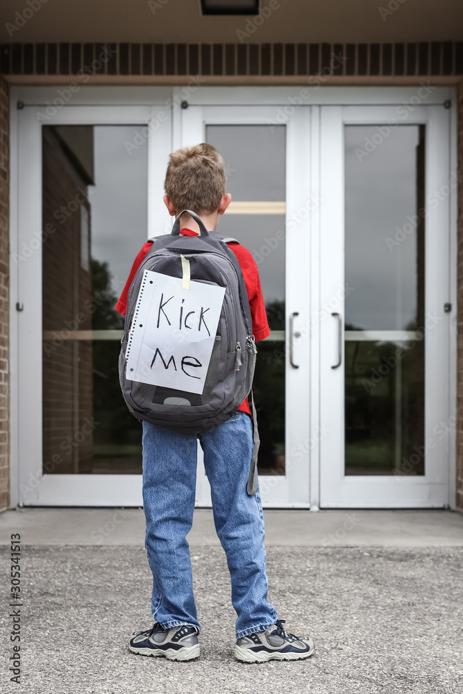 Sad boy with a kick me sign taped to his back, bullying Stock-Foto ...