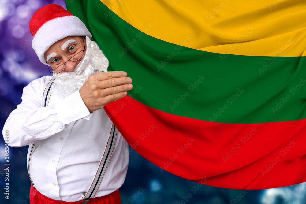 Santa Claus with a beard holds a beautiful colored national flag of the ...