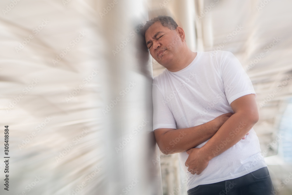 old senior man with stomach ache; retired man suffering from ...