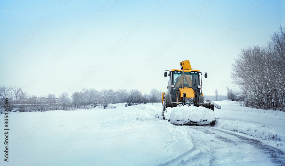 Snow clearing. Tractor clears the way after heavy snowfall. Stock Photo ...