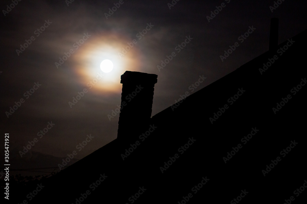 month above the house,at night the full moon shines over the house, the ...