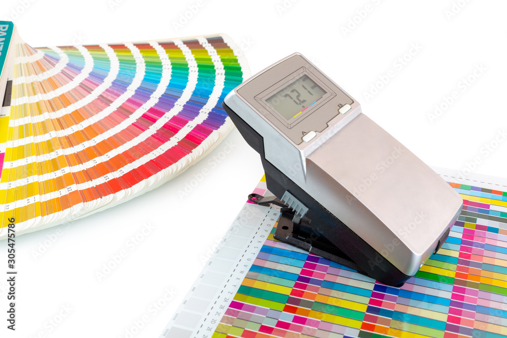 Printed color swatch, density meter and paint guide isolated on white ...