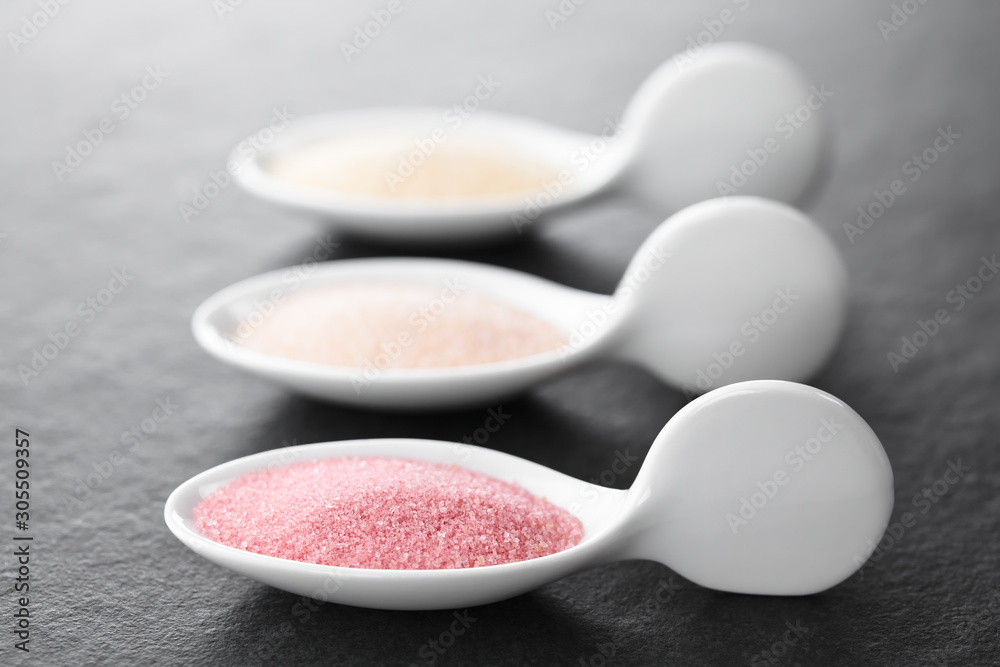 Red, orange and yellow instant jelly or jello powders on small spoons ...