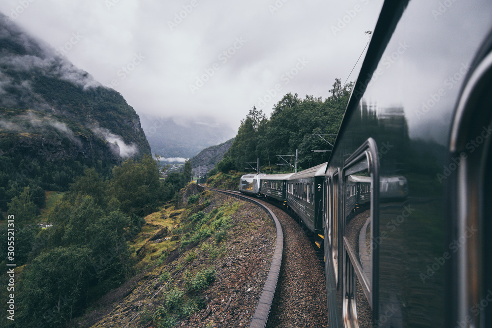 Reflection in train window of Flamsbana mountain railway in Flam ...