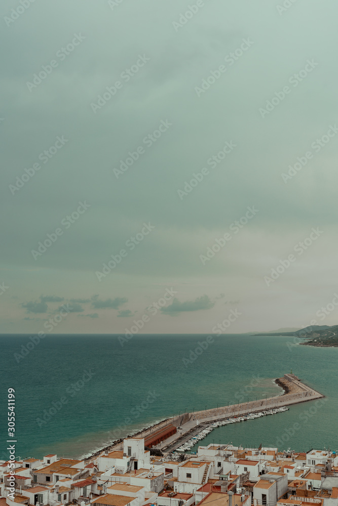 Aerial view of sea port with tightly stayed buildings with red roofs ...