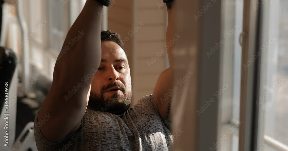 Man exercising in a gym making his muscles more stronger, healthy ...