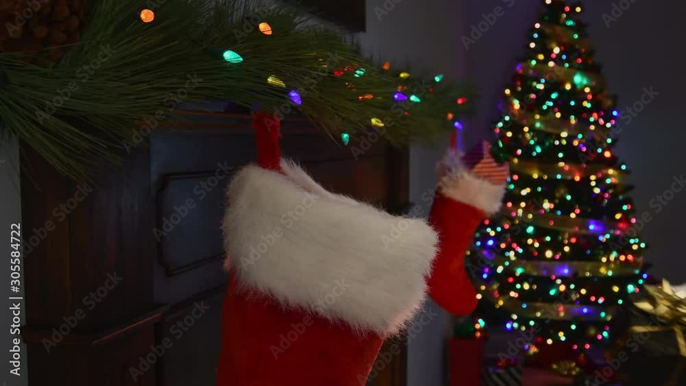 A close-up of Santa Claus’s hand placing a large lump of coal into a ...