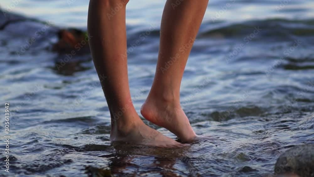 Female in a bikini on a rocky beach in slow motion. Beautiful bikini ...