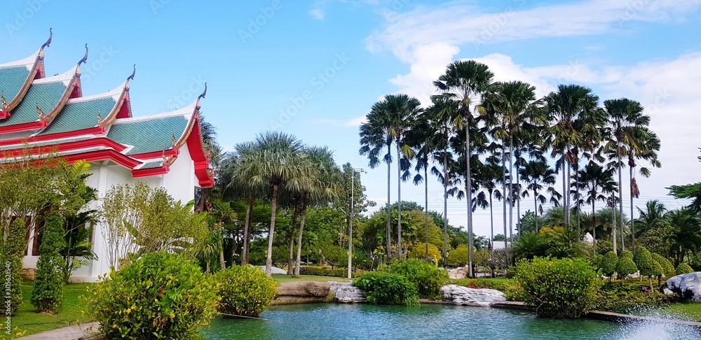 Beautiful ancient temple with many green tree, coconut or palm and lake ...