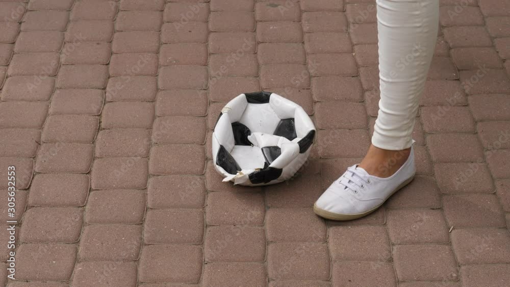 Angry female jump on crumpled ball, push it down by feet then kick away ...