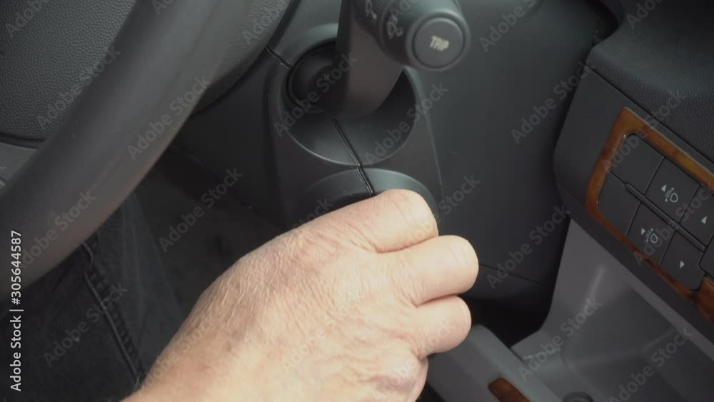 Slow motion close shot of a man’s hand flicking open a vehicle key ...