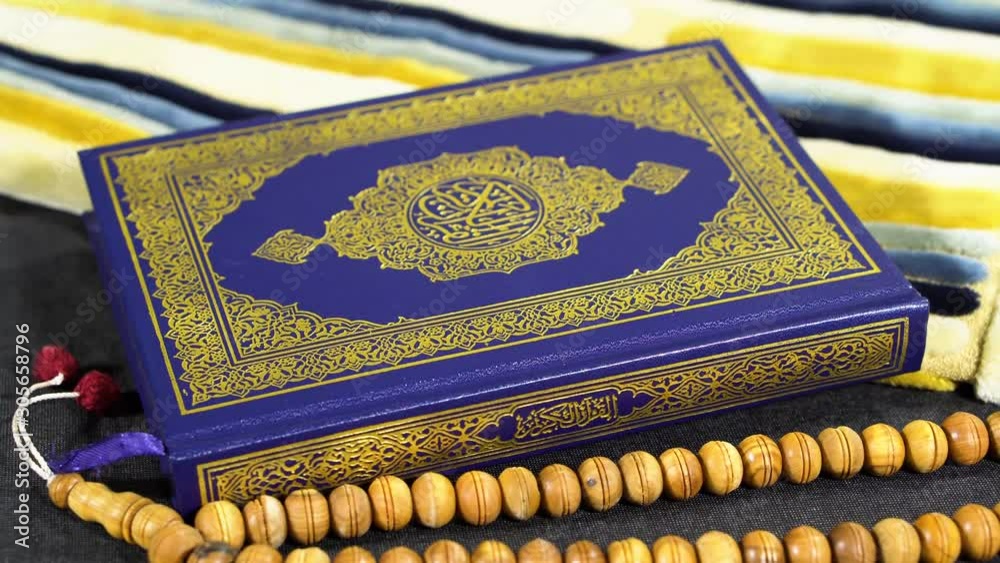 Tilt up shot of Muslims Holy Book Quran Kareem AL Quran Majid with ...