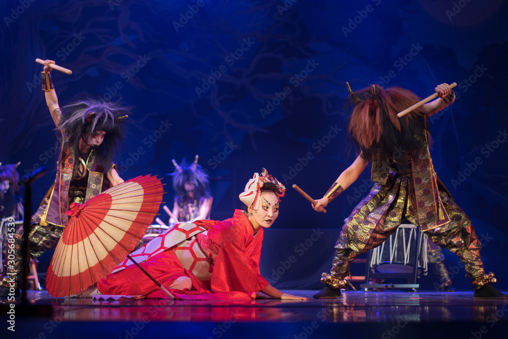 Traditional Japanese performance. Actress in traditional red kimono and ...