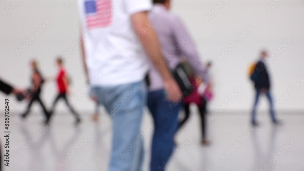 Blurred crowd of people walking by in a convention hallway Stock Video ...