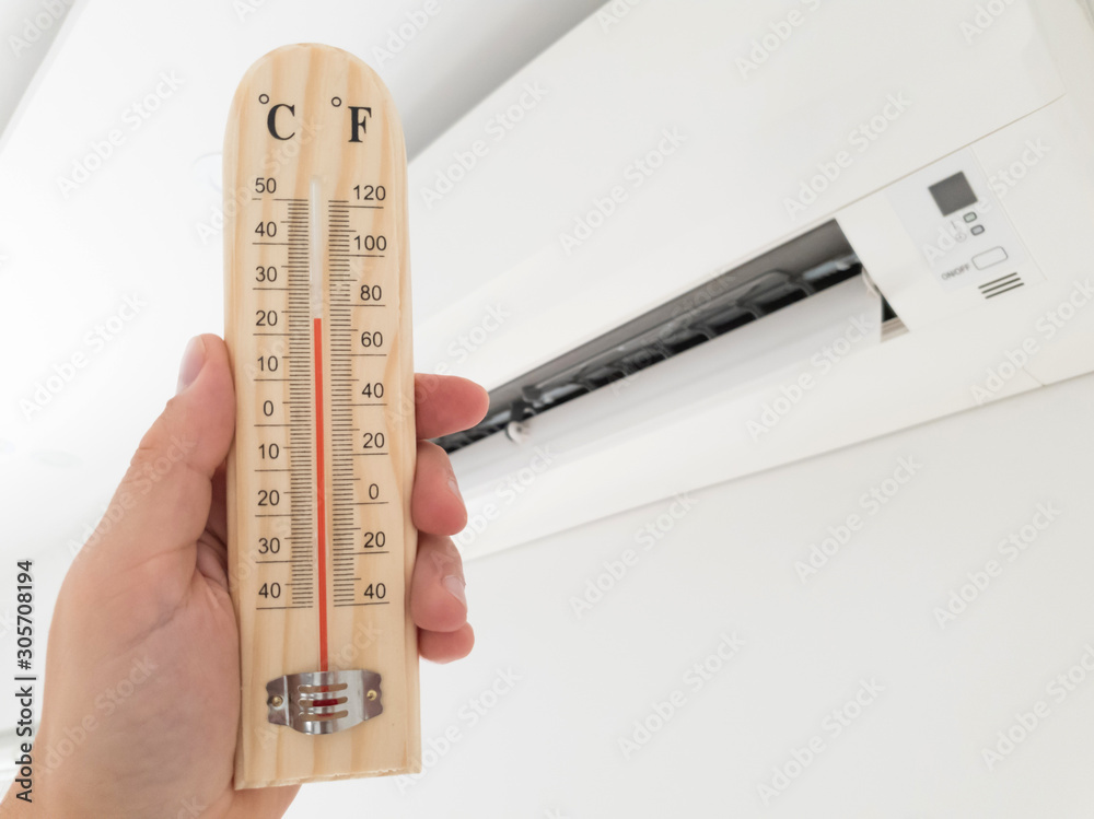 Thermometer and temperature measuring with modern air condition unit on ...
