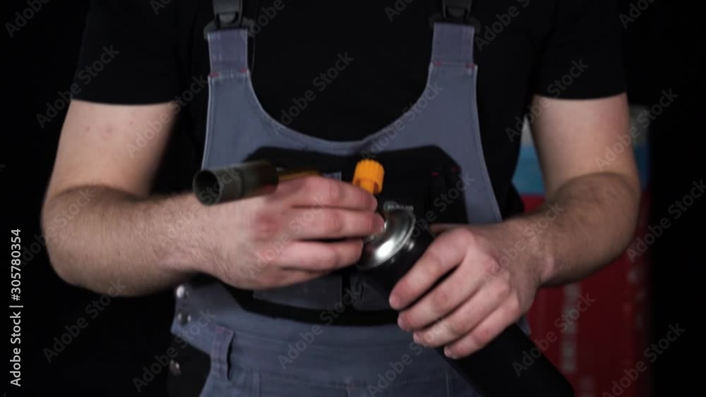 Man worker take manual hand gas burner and fit it on gas balloon. Stock ...