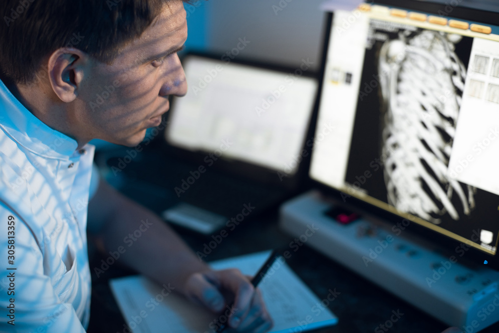 in medical laboratory patient undergoes MRI or CT scan process under ...