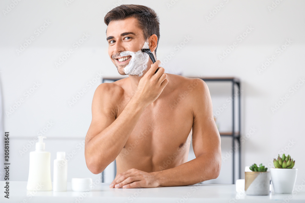 Handsome young man shaving at home Stock Photo | Adobe Stock