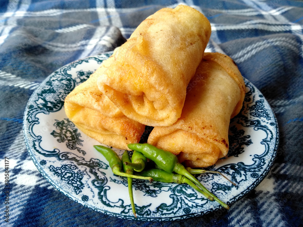Makanan Lumpia Goreng or fried spring rolls with chili. Lumpia Goreng ...
