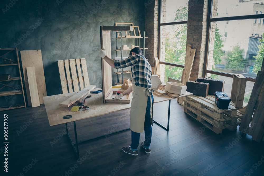 Back rear side full length photo of concentrated worker handcraft ...