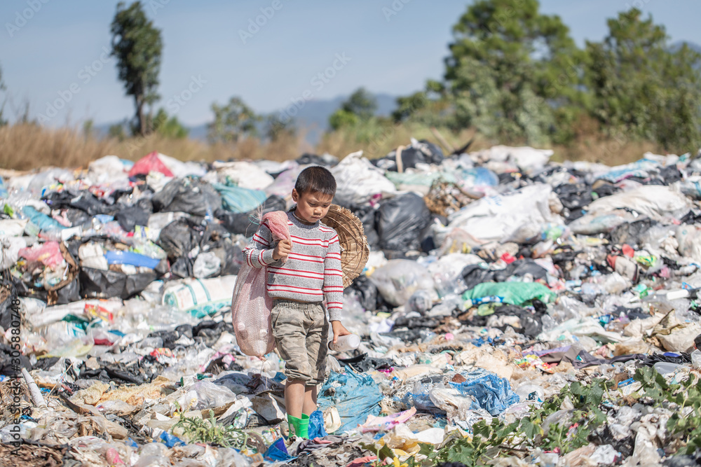 Poor boy collecting garbage in his sack to earn his livelihood, The ...