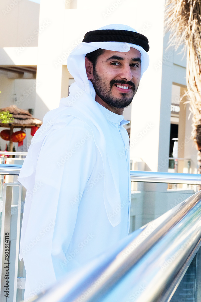 Arab man wearing Emirati Kandoora. Modern Arabic MIddle Eastern man ...