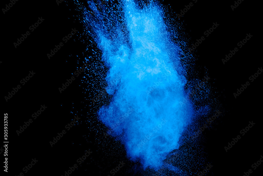 Abstract blue dust explosion on black background. Freeze motion of blue ...