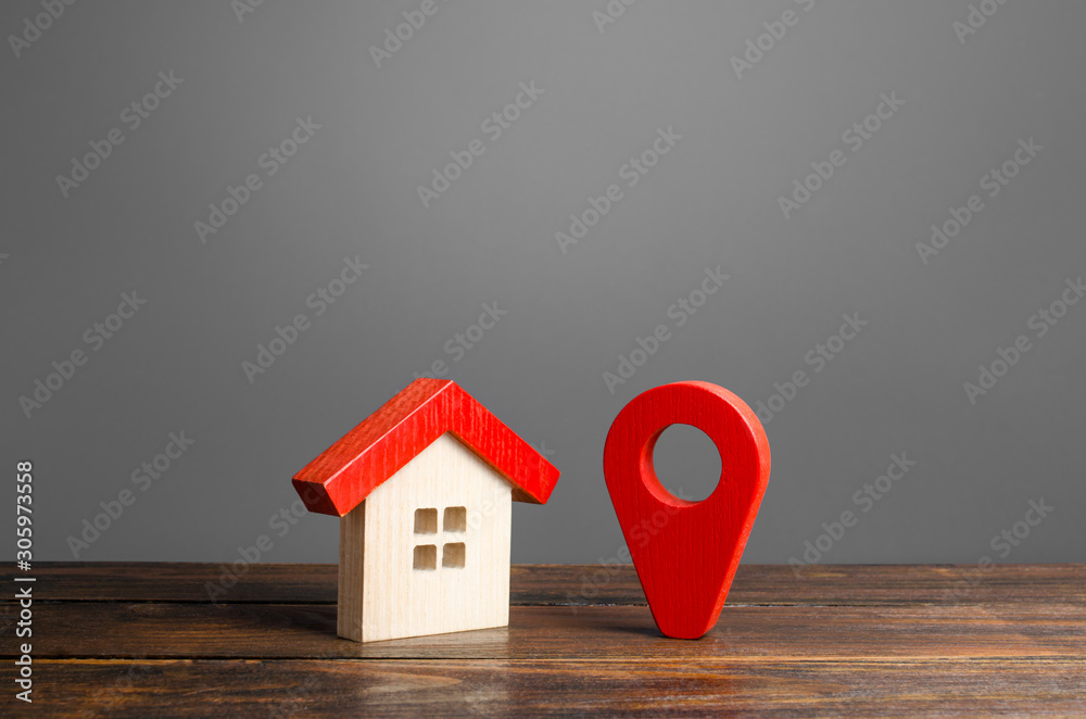 Figurine wooden house and red location pointer. Location and ...