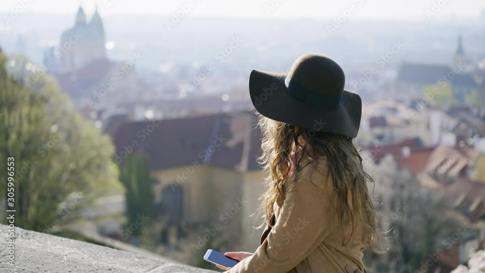 Woman in brown hat writing in the diary on view point with amazing view ...