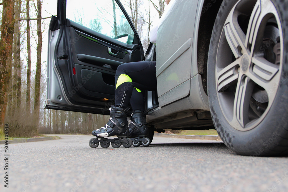 Men's legs on roller skates in a car. The choice of a healthy lifestyle ...