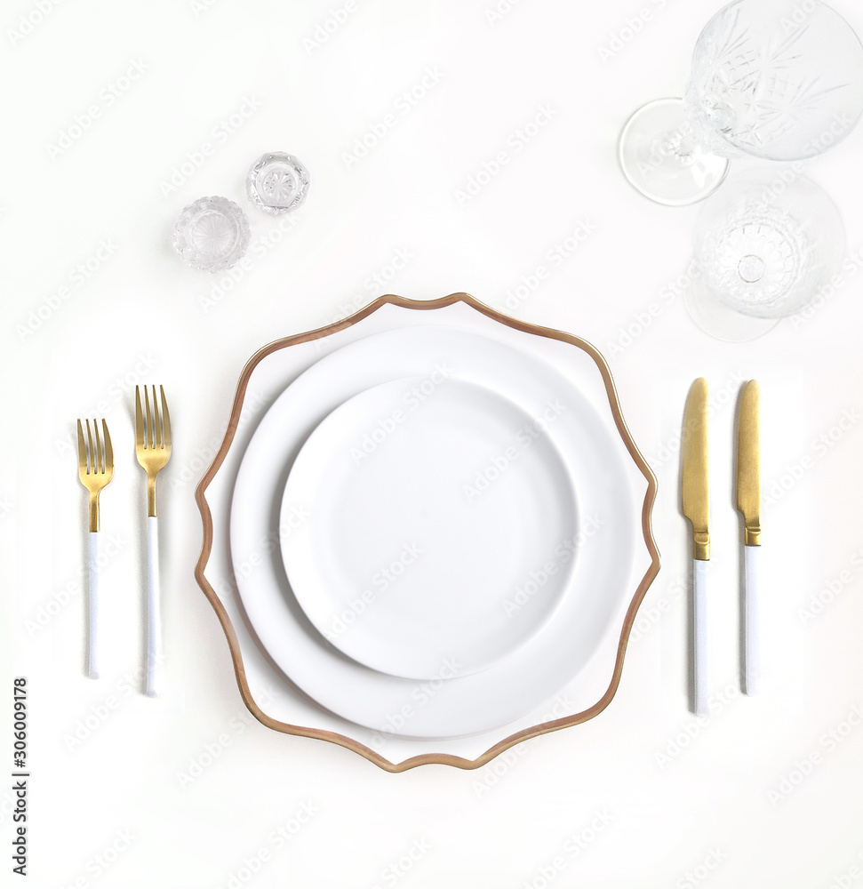 New luxury white ceramic plate, golden cutlery view from above on a ...