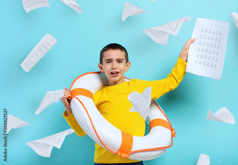 Young boy student is drowning in a sea of sheets of exercises. Cyan ...