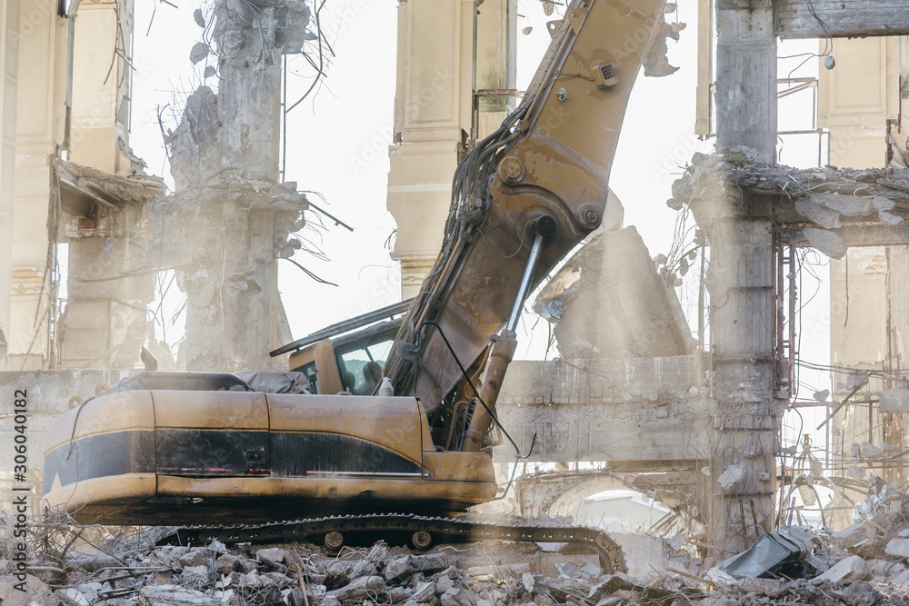 Building demolition excavator with long mechanical arm. Destruction of ...
