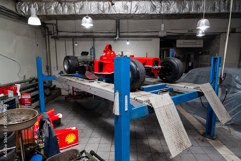 The process of repairing and restoring a red Ferrari Formula 1 car at a ...