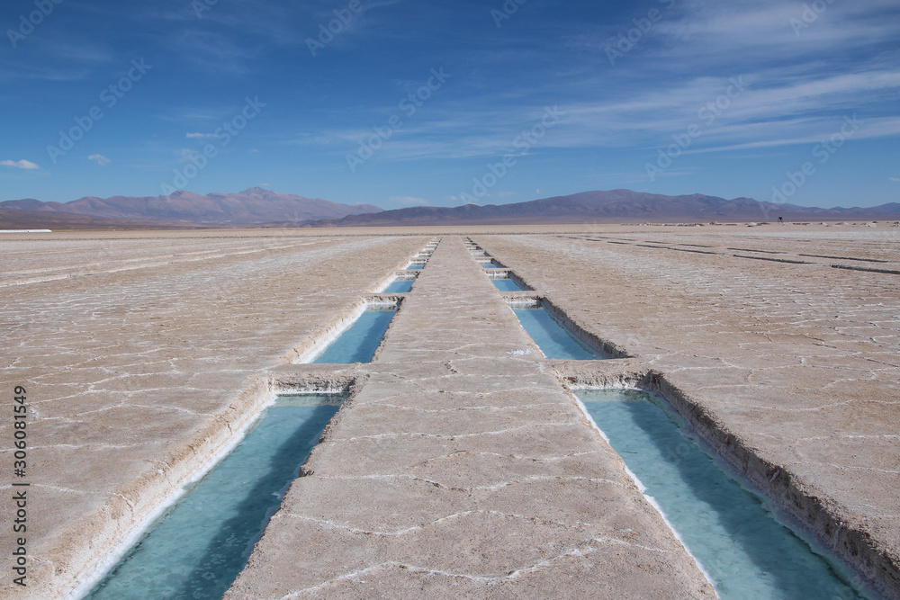 Blue water swimming pool dug in the salt desert of the Salinas Grandes ...