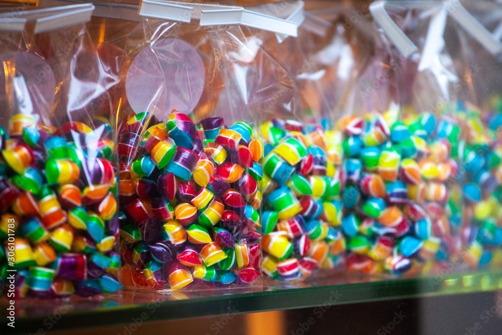 colorful sweet candy on display in bags in storefront Stock Photo ...
